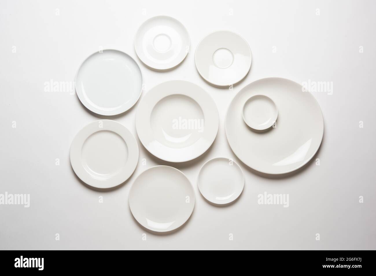 different shape white plates isolated on white background, top view ...