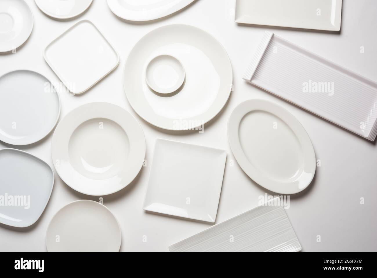 different shape white plates isolated on white background, top view ...