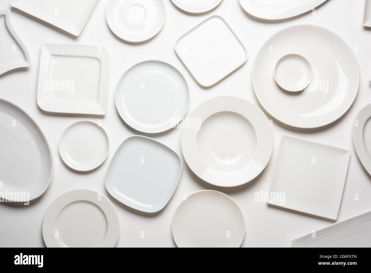 different shape white plates isolated on white background, top view ...