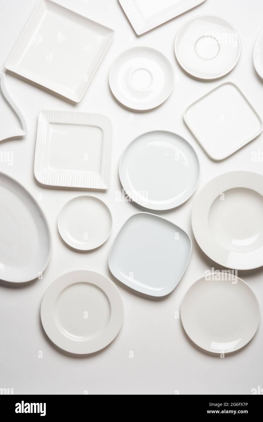 different shape white plates isolated on white background, top view ...