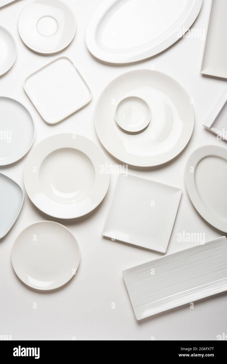 different shape white plates isolated on white background, top view ...