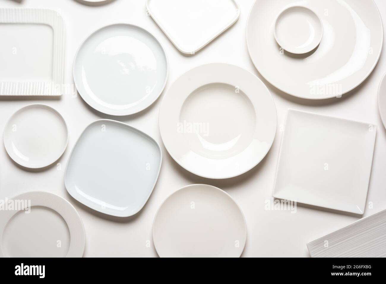 different shape white plates isolated on white background, top view ...