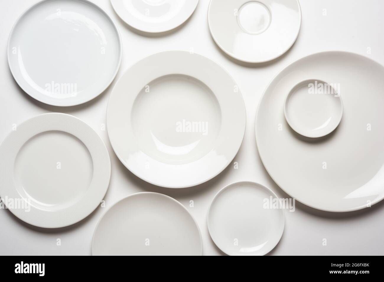 different shape white plates isolated on white background, top view ...
