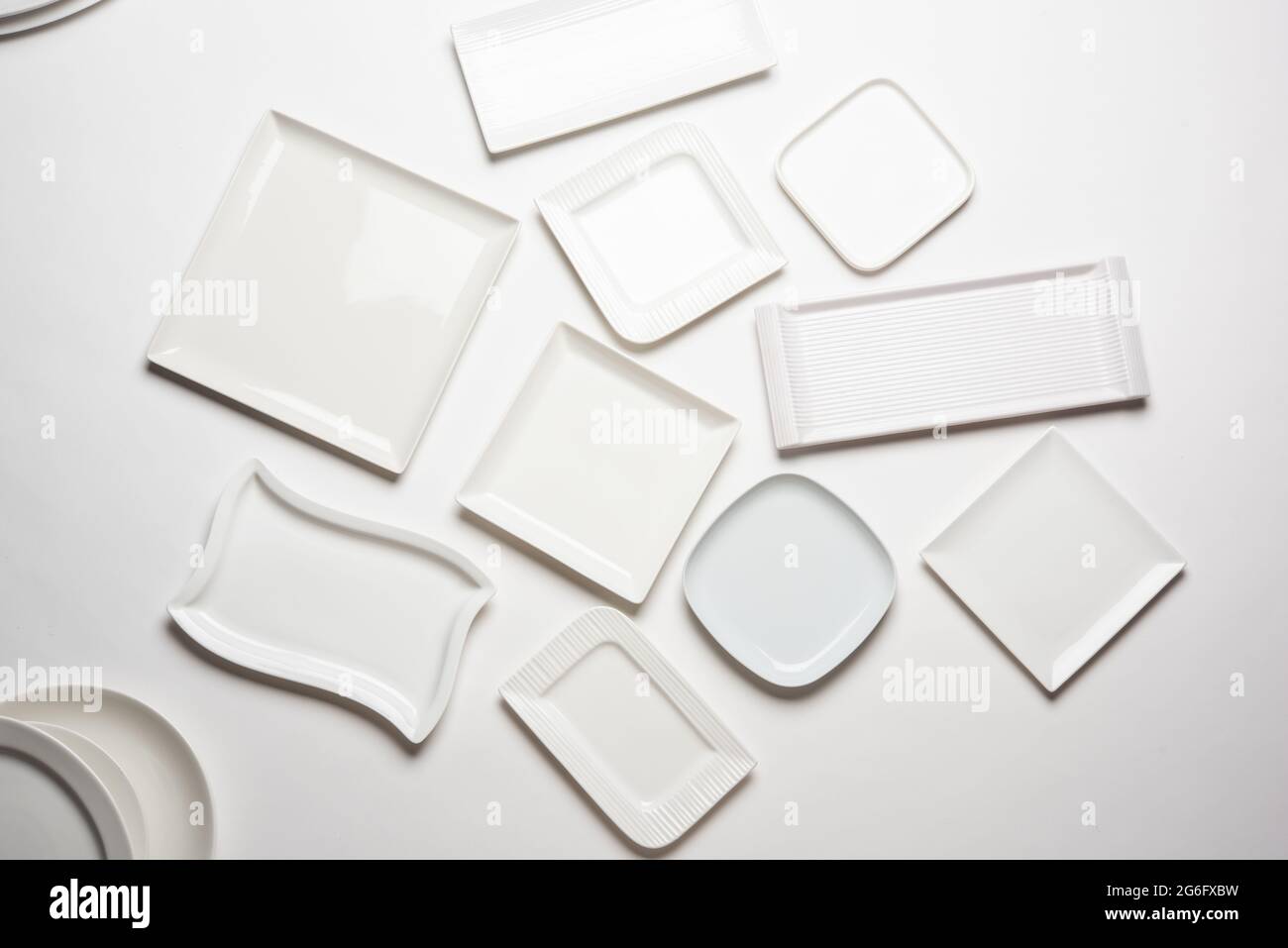 different shape white plates isolated on white background, top view ...