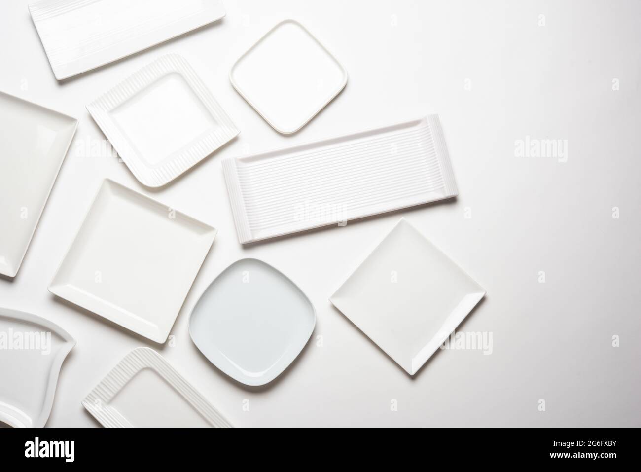 different shape white plates isolated on white background, top view ...