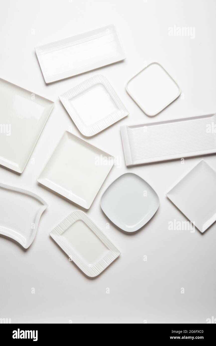 different shape white plates isolated on white background, top view ...