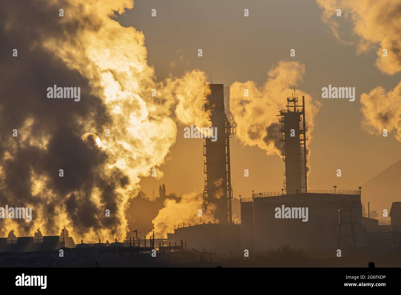 Smoke of factory spreading in a sunny sky Stock Photo - Alamy