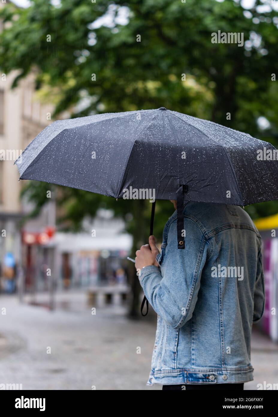 Person in rain coat storm hi-res stock photography and images - Alamy