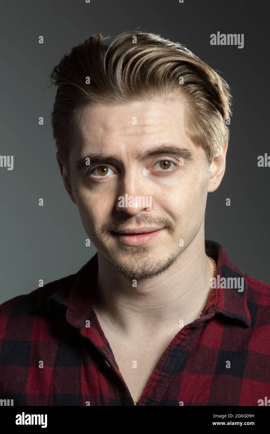 Studio portrait confident blonde man Stock Photo - Alamy
