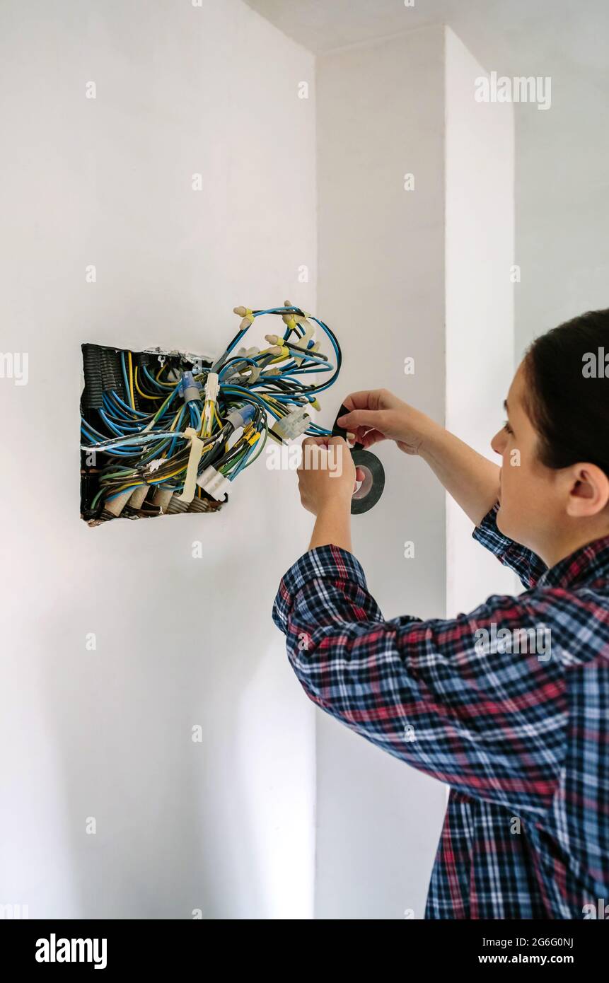 Electrician working on the electrical installation of a house Stock ...