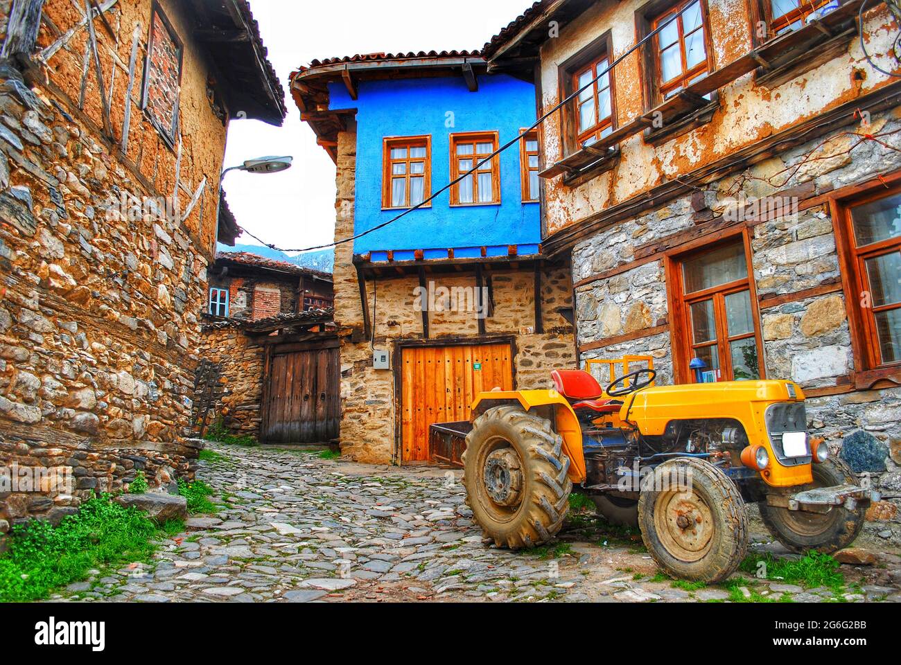 Historical village houses and agricultural vehicle tractor. Cumalıkızık ...