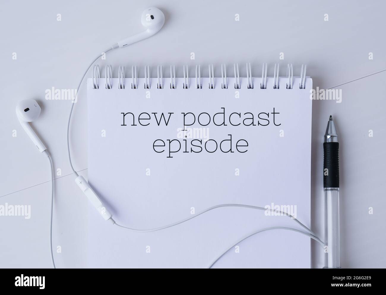Notebook with NEW PODCAST EPISODE available now lettering. Headphones ...