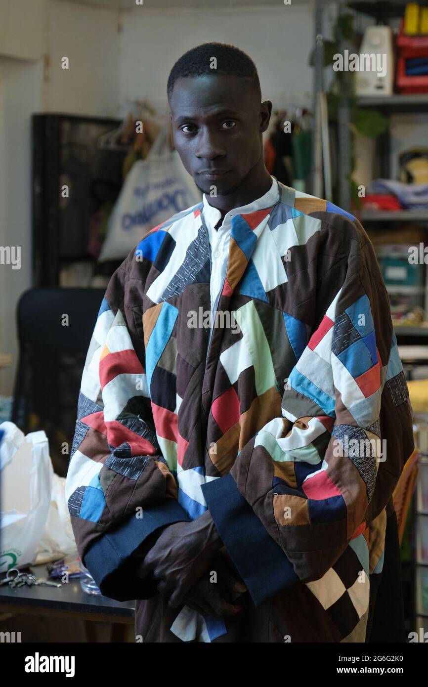 Portrait of an african man wearing traditional colorful clothes and hat ...