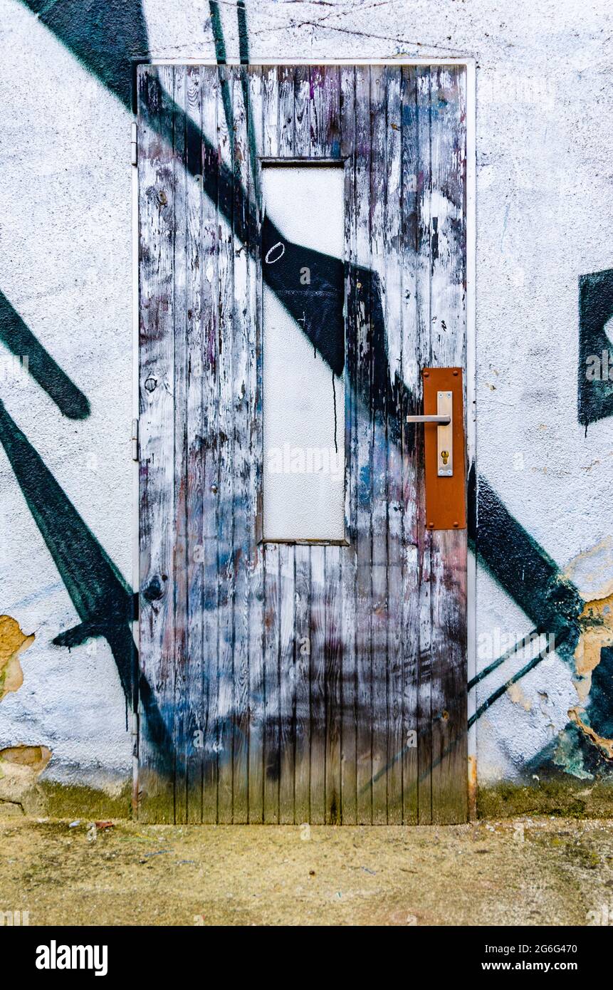 Painted old ugly door - graffiti on building exterior Stock Photo - Alamy