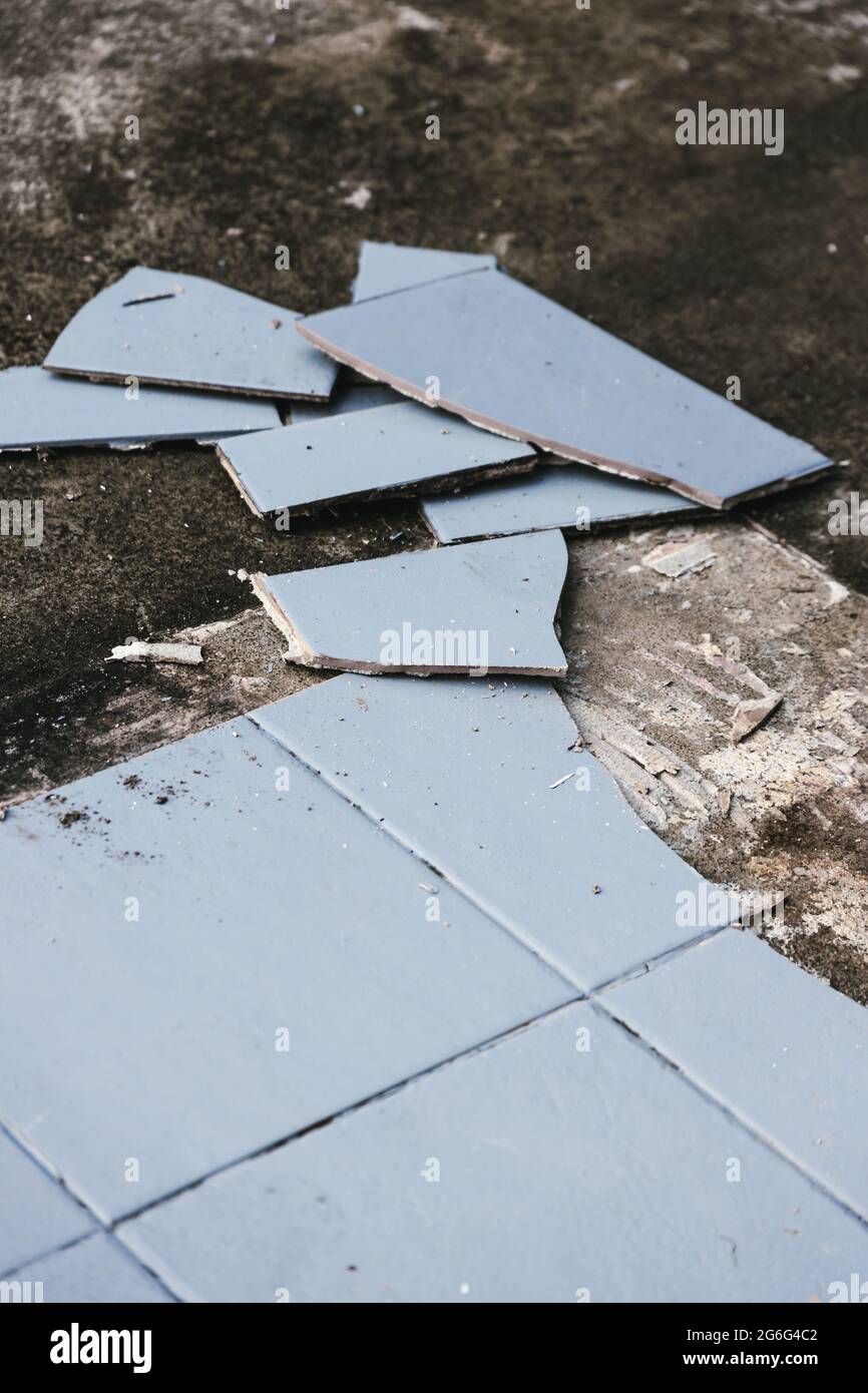 blue outdoor tiles getting ripped up to reveal concrete paving ...