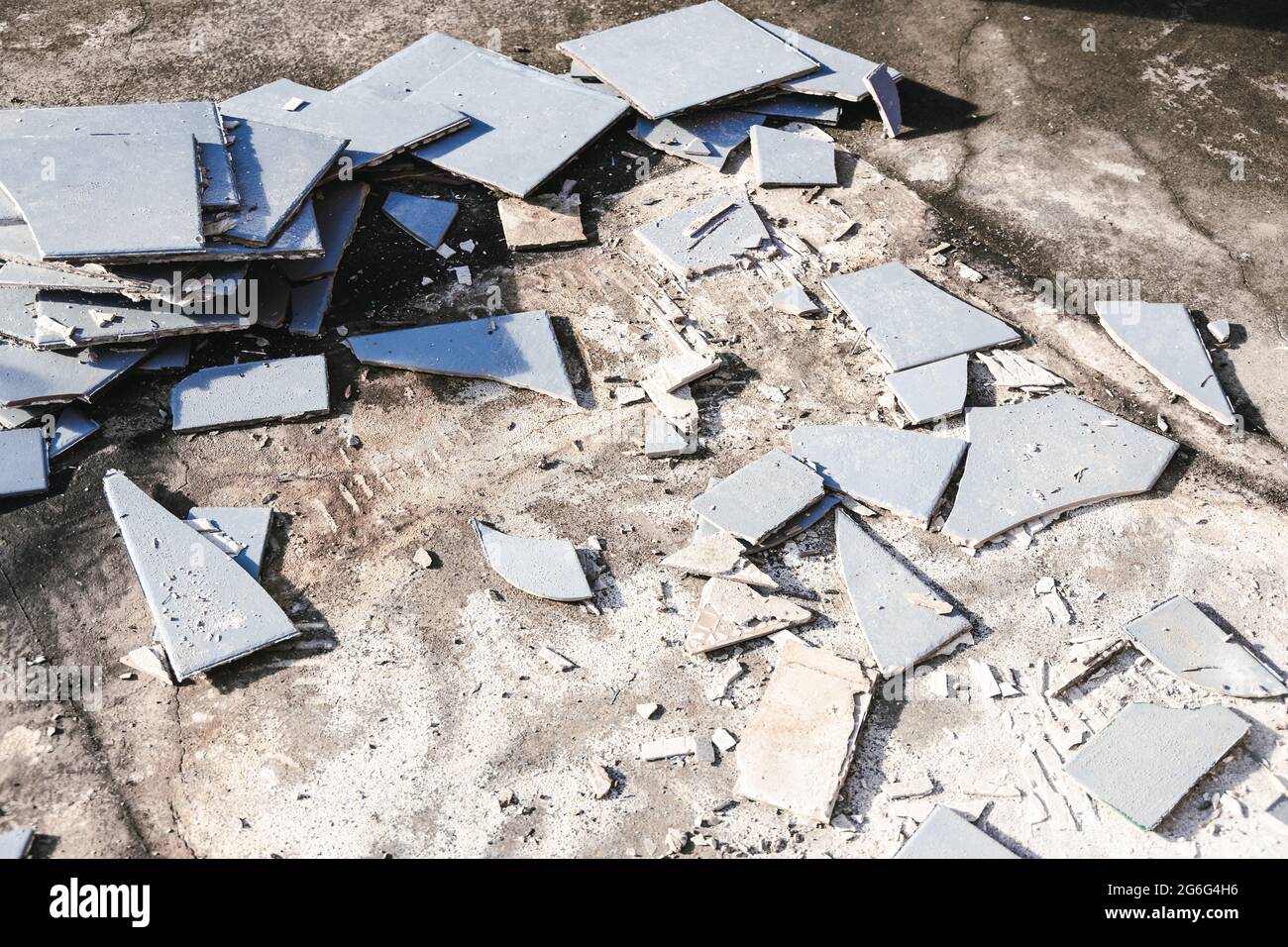 blue outdoor tiles getting ripped up to reveal concrete paving ...