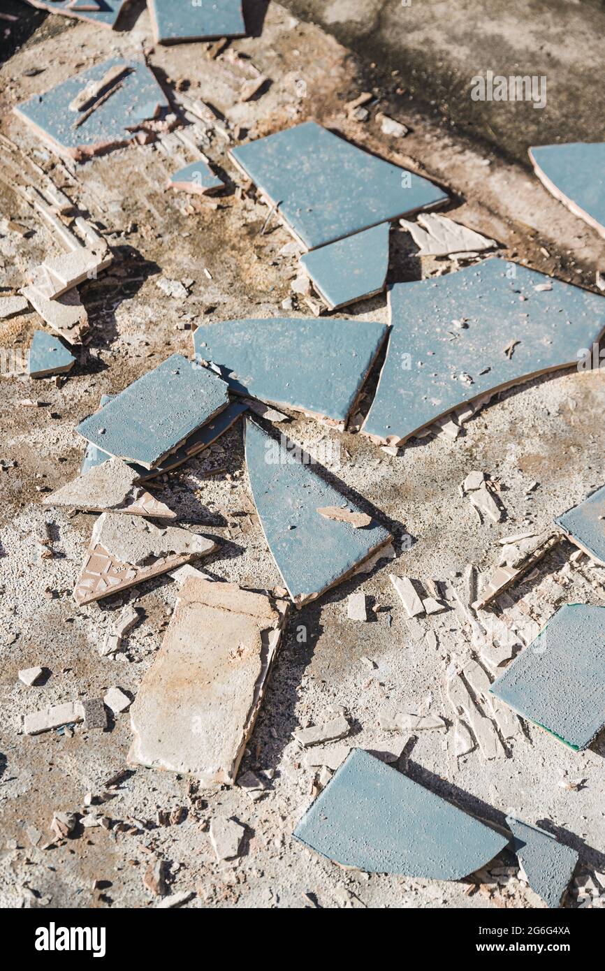 blue outdoor tiles getting ripped up to reveal concrete paving ...