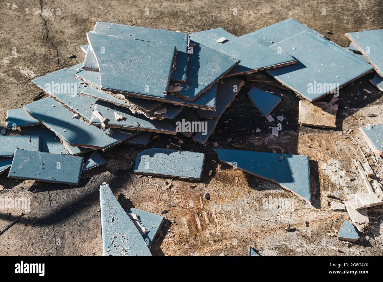 blue outdoor tiles getting ripped up to reveal concrete paving ...