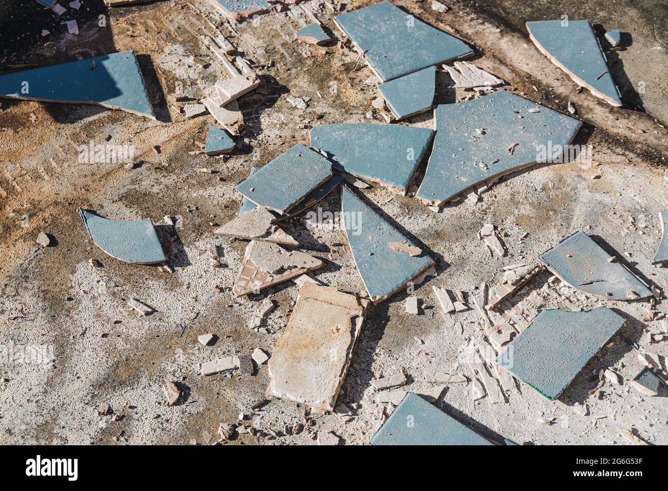 blue outdoor tiles getting ripped up to reveal concrete paving ...