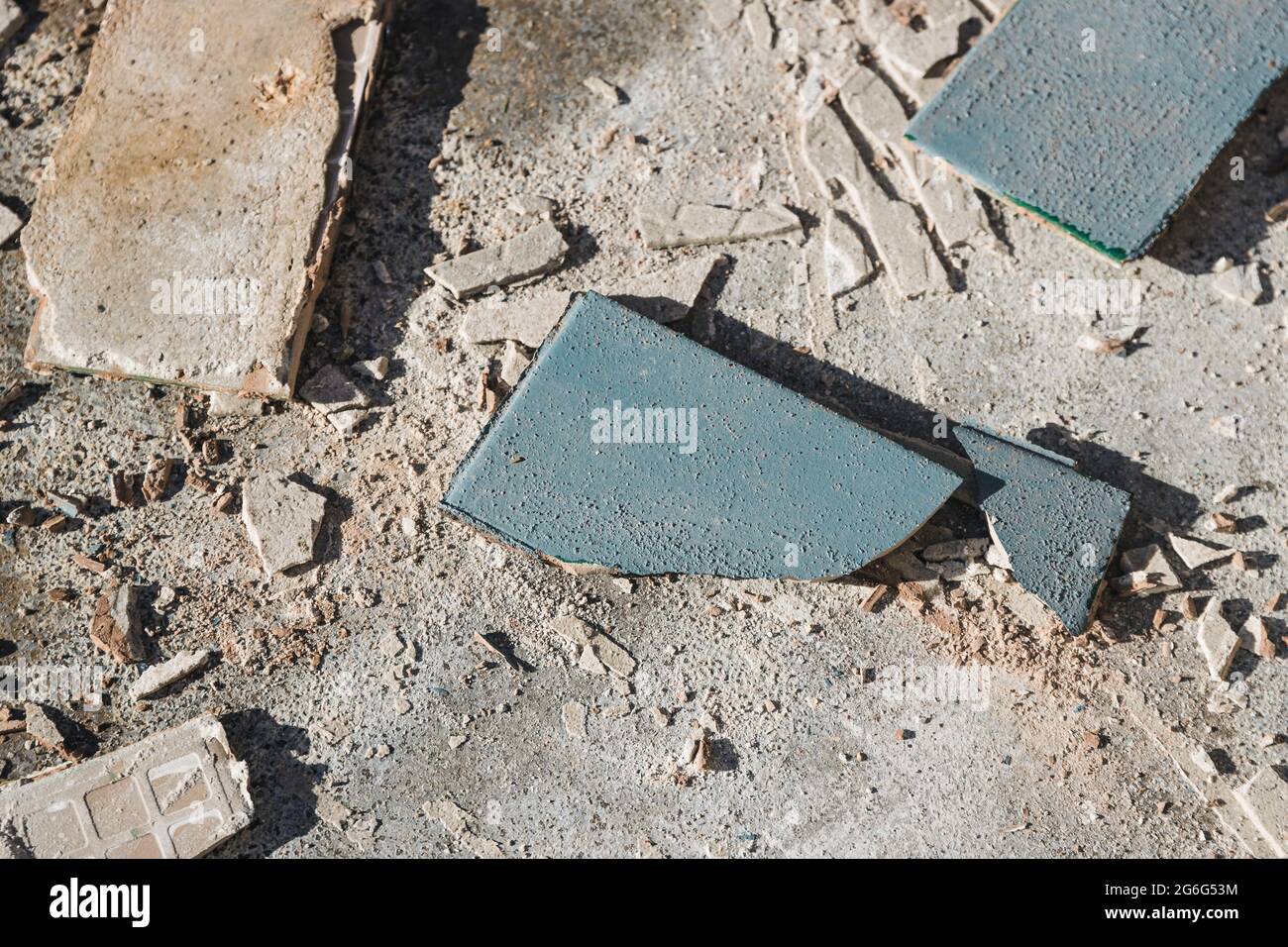 blue outdoor tiles getting ripped up to reveal concrete paving ...