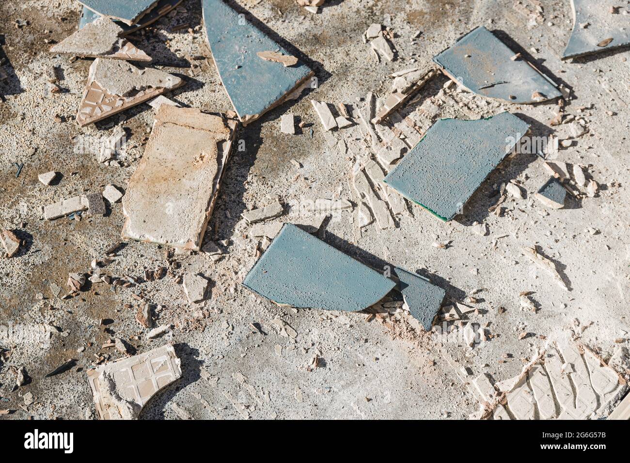 blue outdoor tiles getting ripped up to reveal concrete paving ...