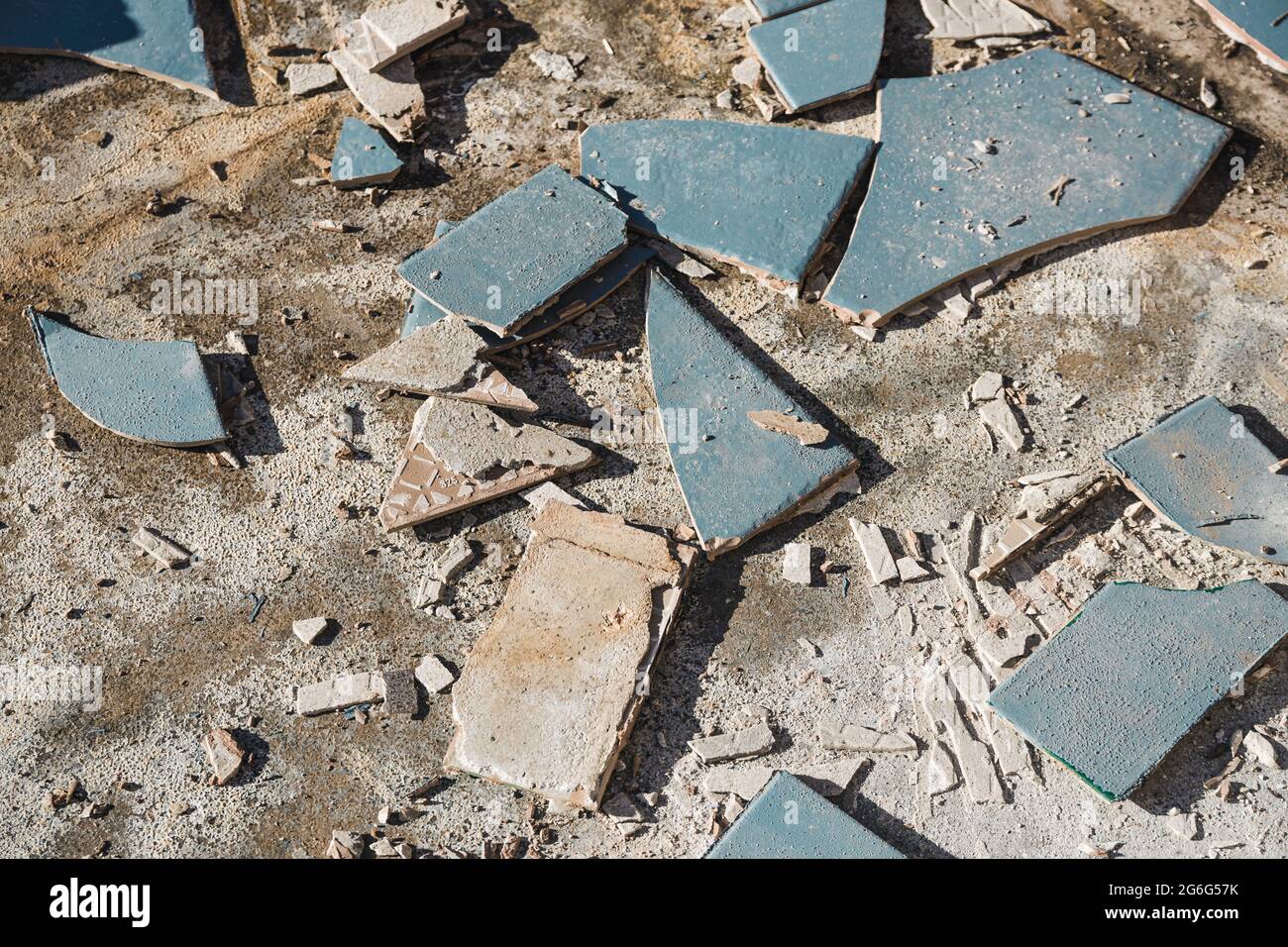 blue outdoor tiles getting ripped up to reveal concrete paving ...