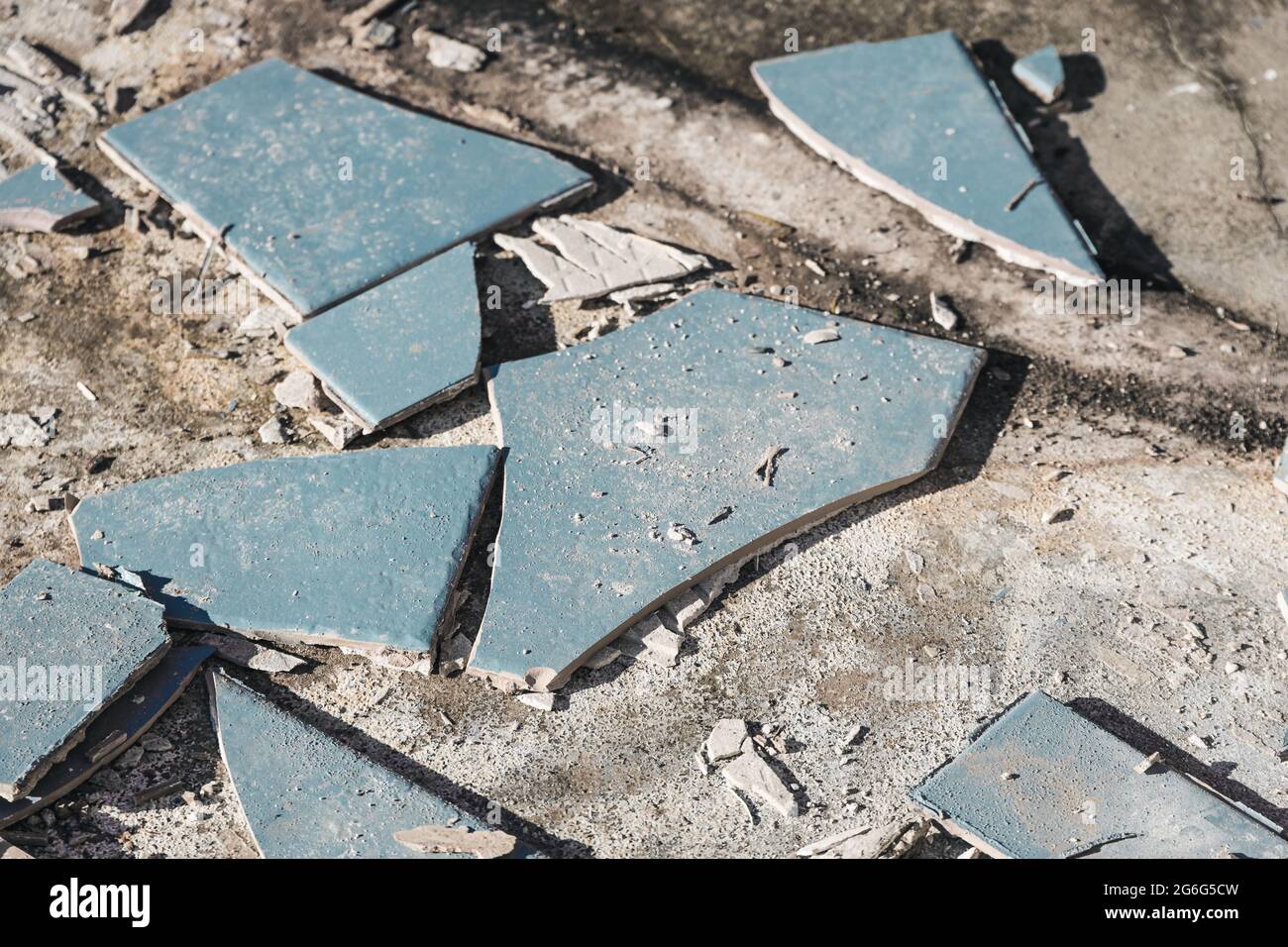blue outdoor tiles getting ripped up to reveal concrete paving ...