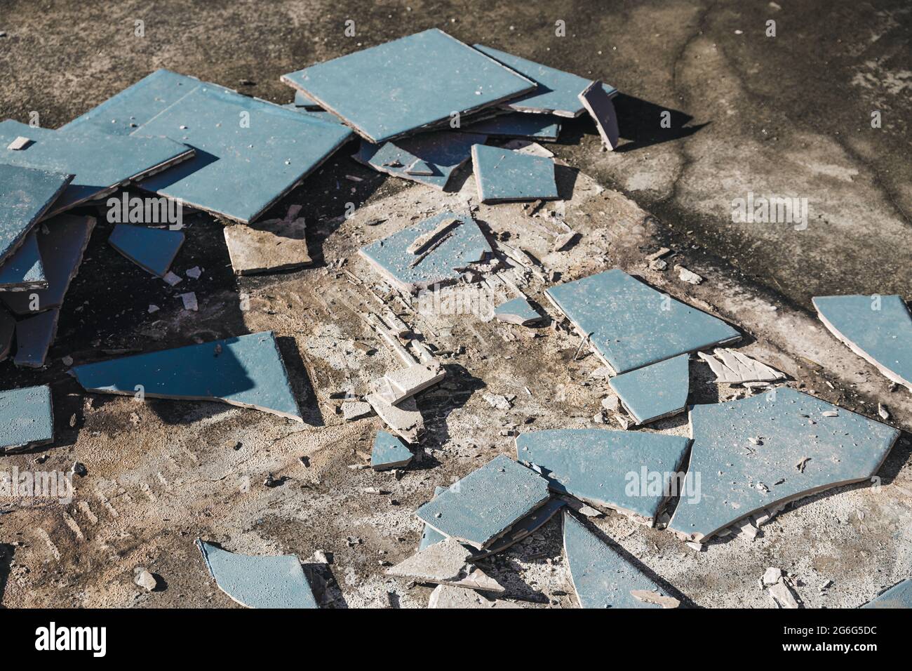 blue outdoor tiles getting ripped up to reveal concrete paving ...