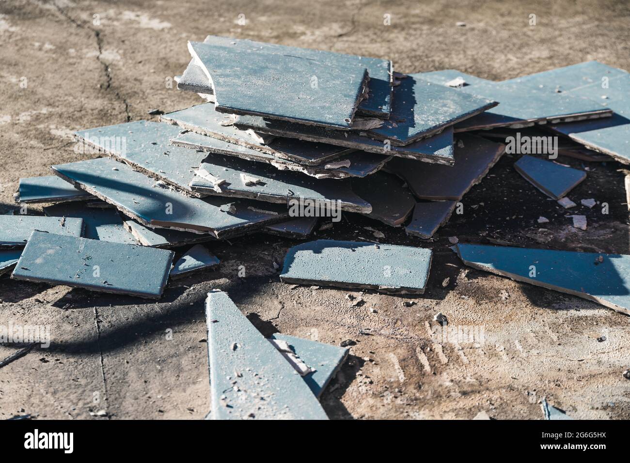 blue outdoor tiles getting ripped up to reveal concrete paving ...