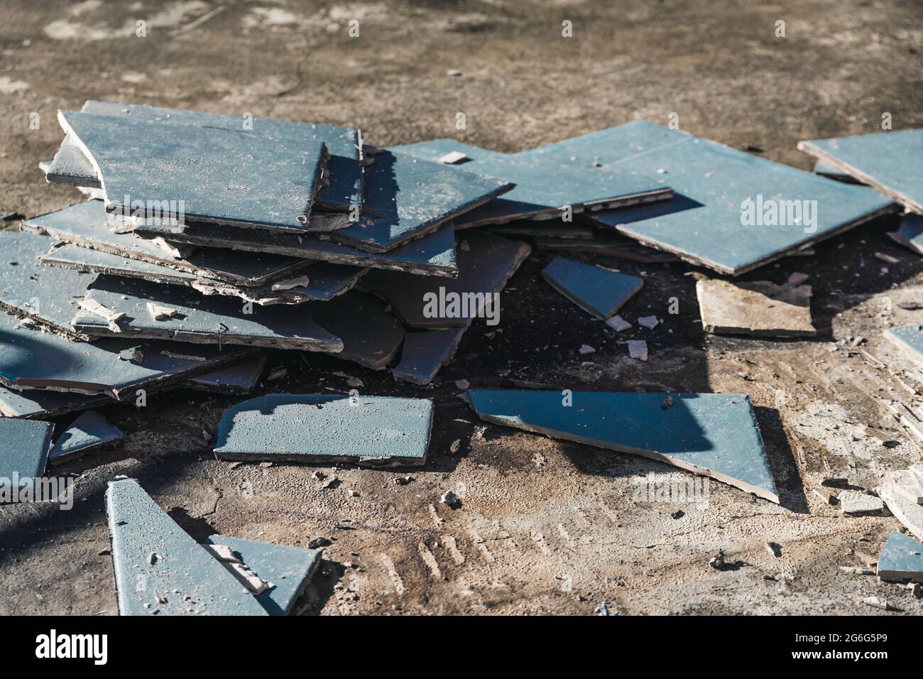 blue outdoor tiles getting ripped up to reveal concrete paving ...