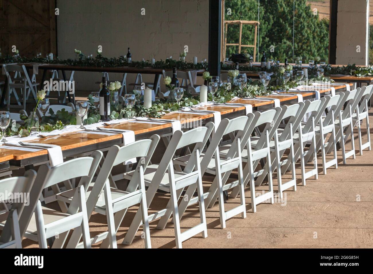 Wedding reception tables dinner food setting for guests inside farm ...