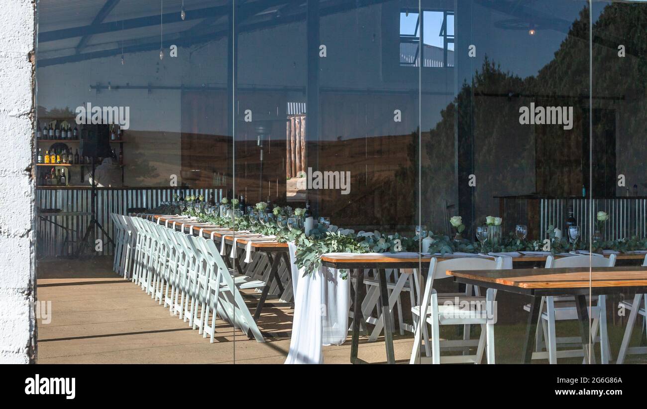 Wedding reception tables dinner food setting for guests inside farm ...