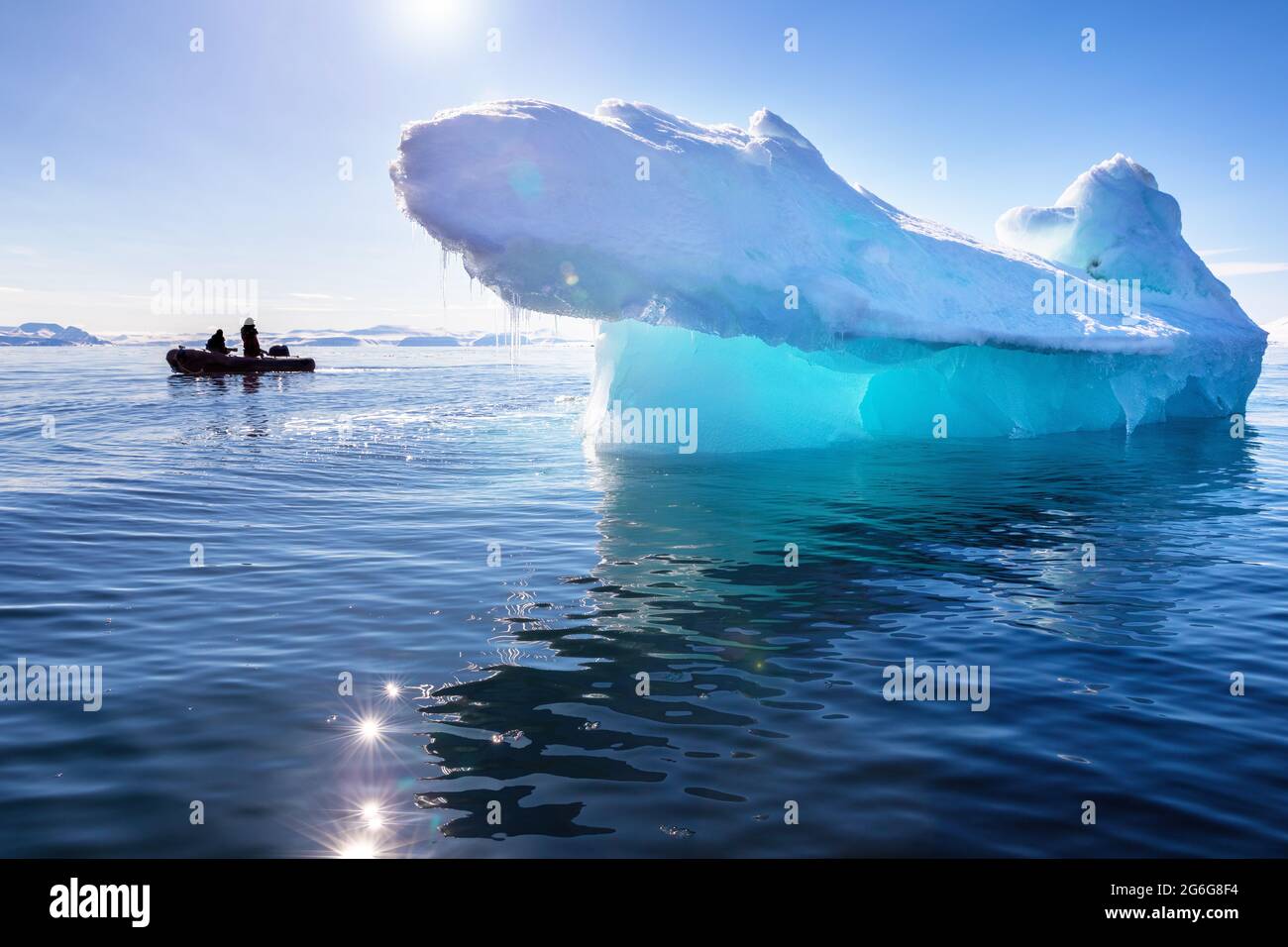 Blue iceberg in Nordfjorden, Svalbard. Sunlight is shining through ...