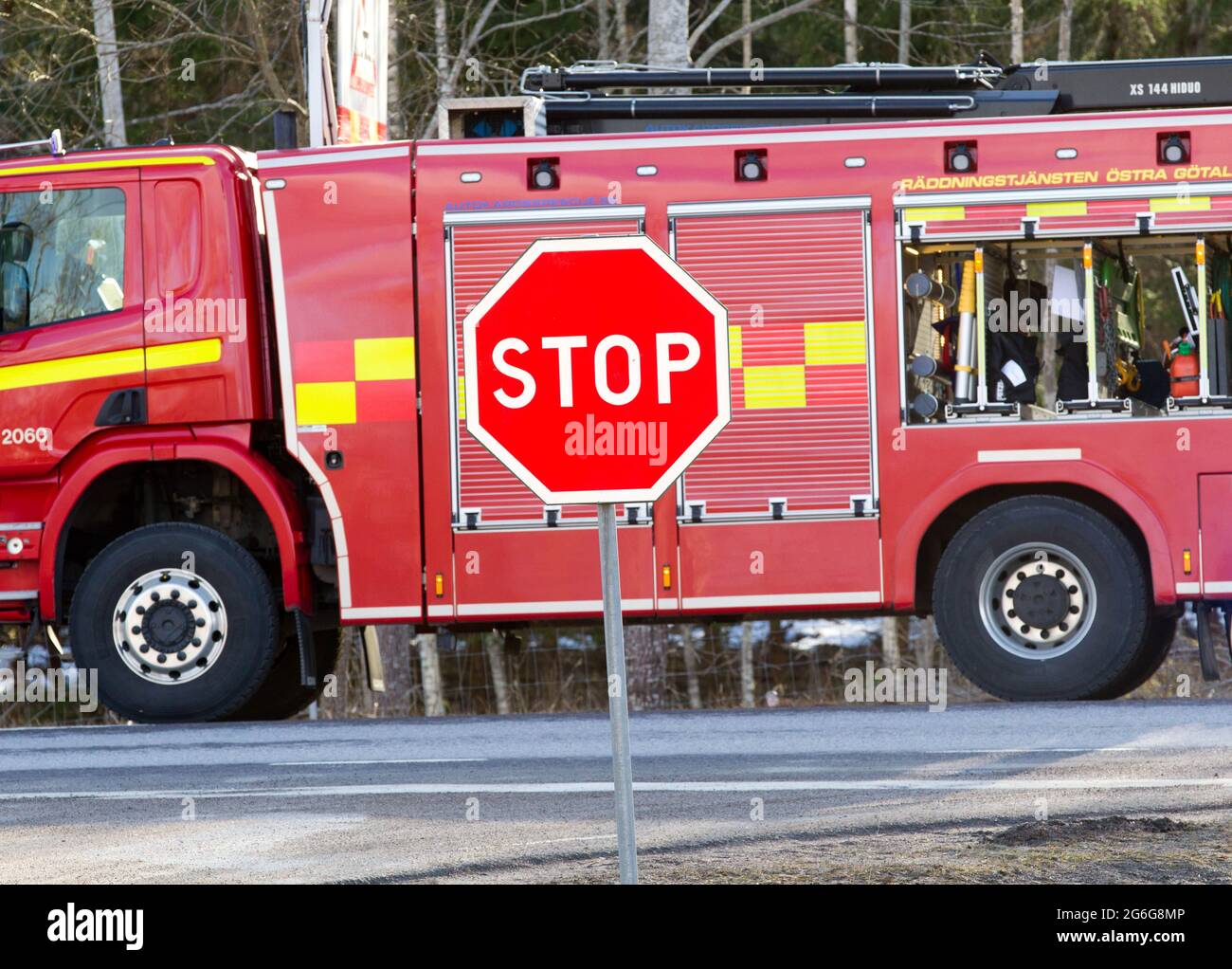 Fire truck at an accident site. A stop sign in the foreground Stock ...