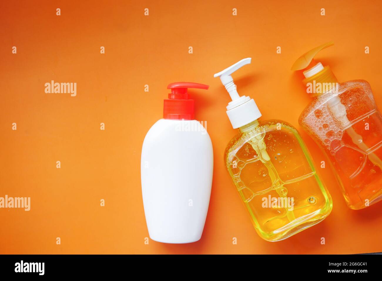hand wash liquid in a container on orange background Stock Photo - Alamy