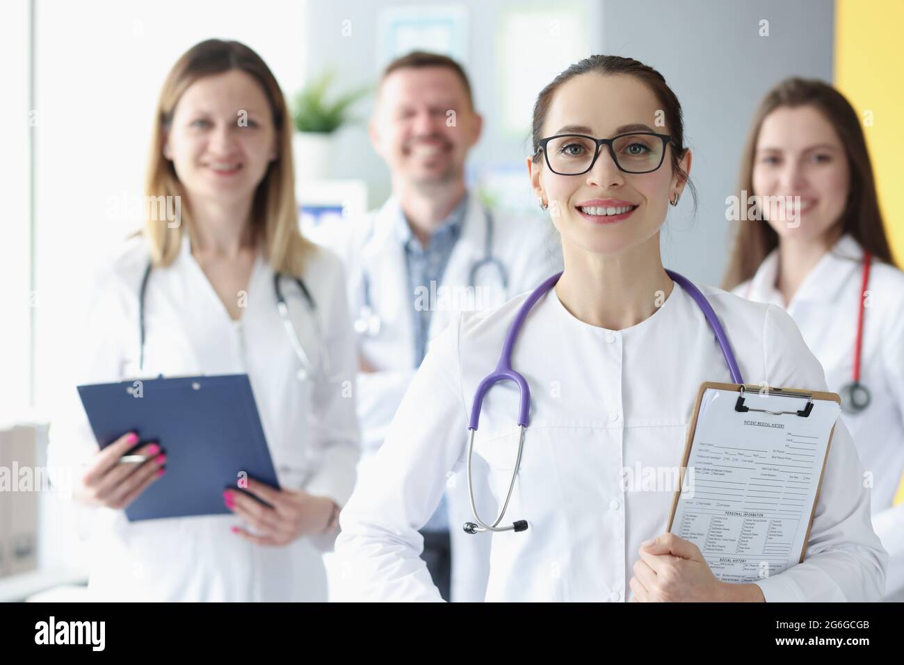 Portrait of medical team standing with clipboard in hospital Stock ...