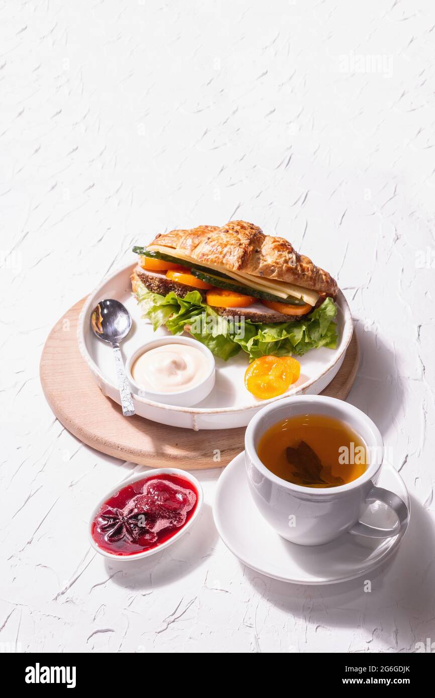 Healthy breakfast concept. Morning good mood with tea, croissant, and ...