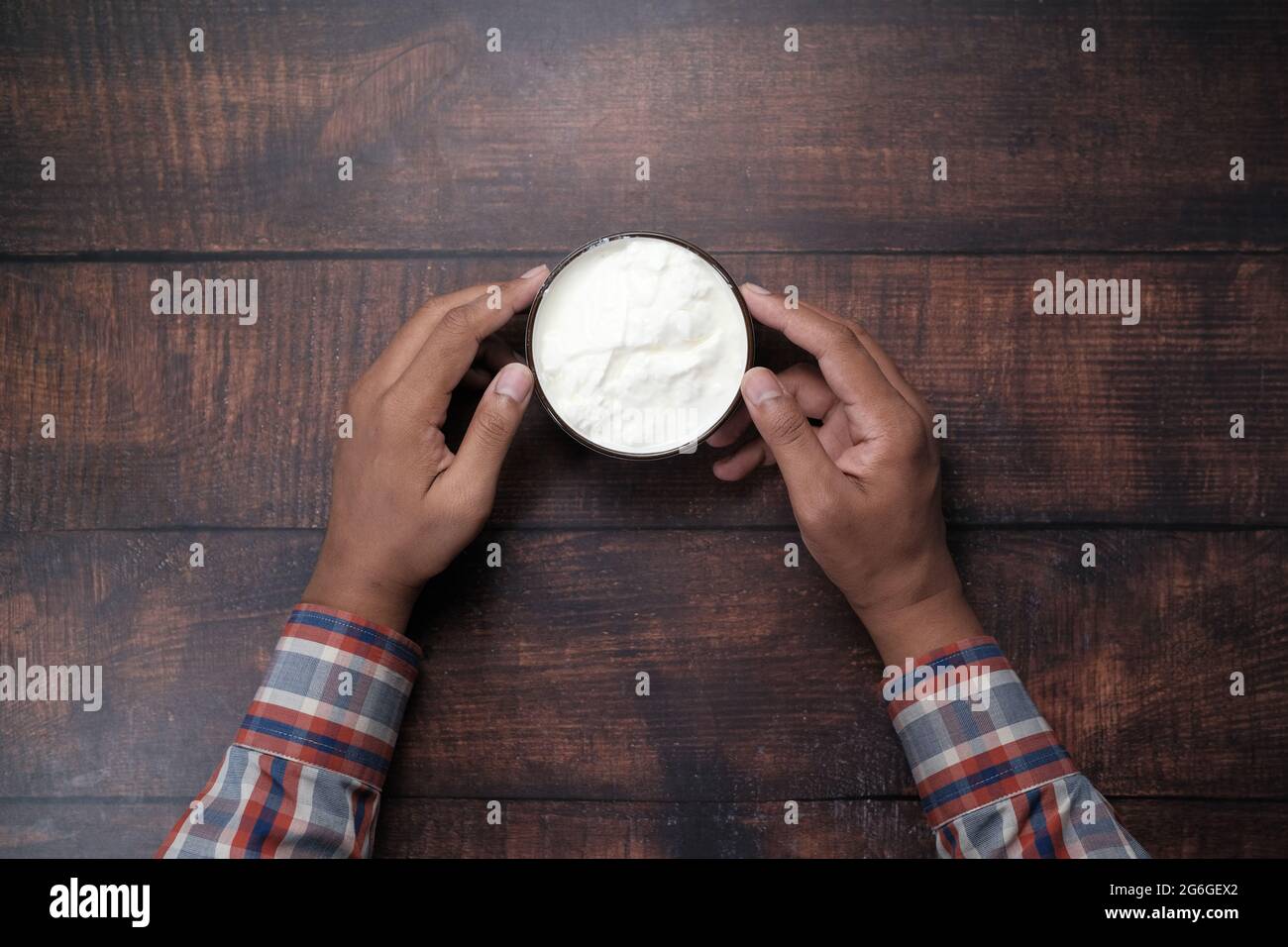 Top view of man's hand eating fresh yogurt from a bowl Stock Photo - Alamy
