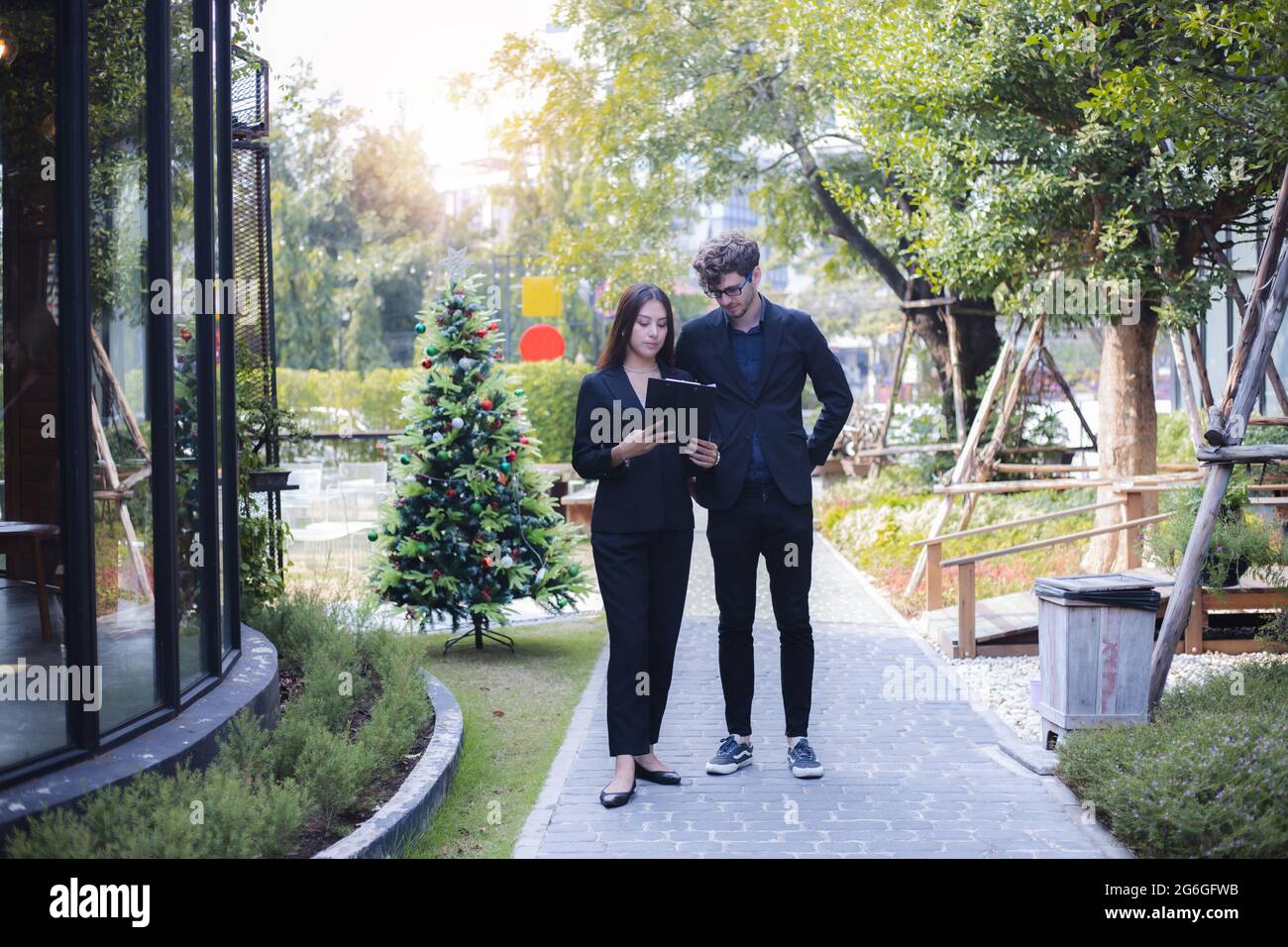 Confidential young business people walk and talk outside office ...