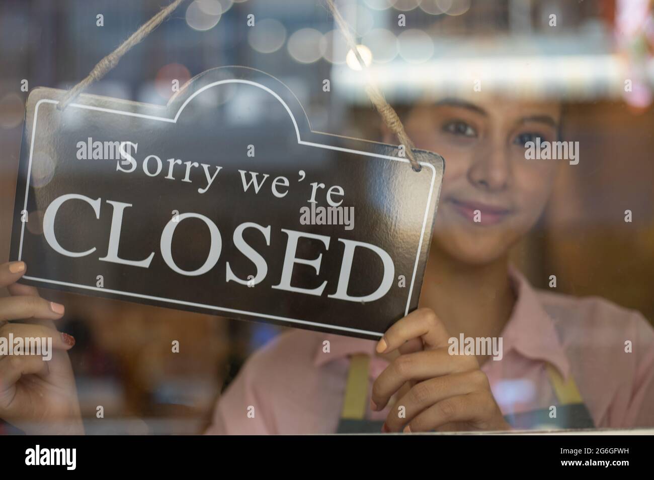 Close up sign, Asian shop owner turn sign to close after lockdown and ...