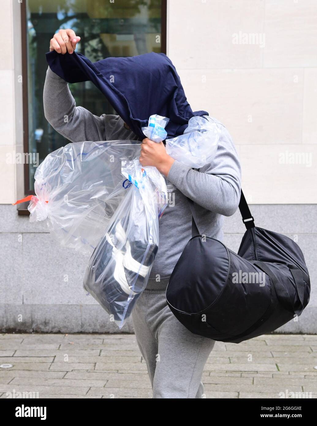 Jonathan Chew, 24, covers his head outside Westminster Magistrates ...