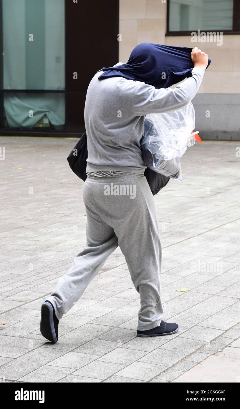 Jonathan Chew, 24, covers his head outside Westminster Magistrates ...