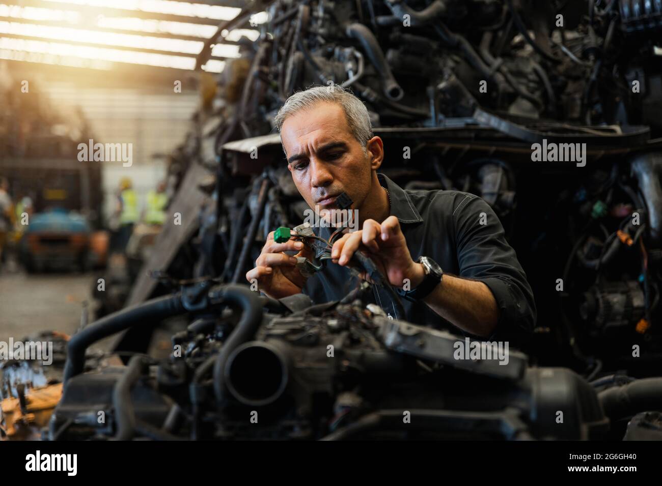 Attractive man working hard and fix Auto mechanic on car engine in ...