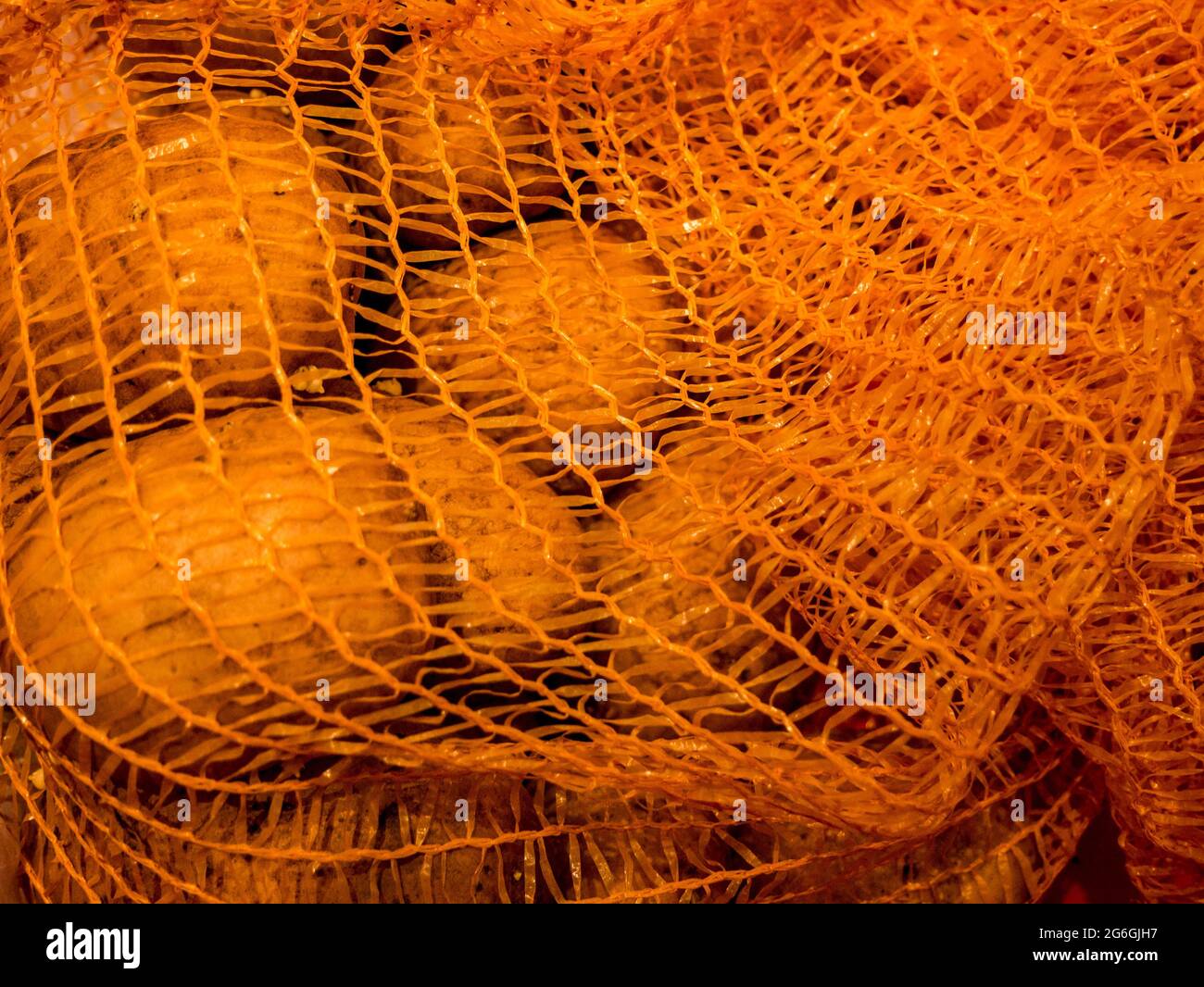 Potatoes in net bag Stock Photo - Alamy