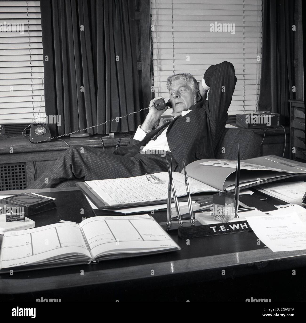 1970s, historical, business executive sitting at his desk on the ...