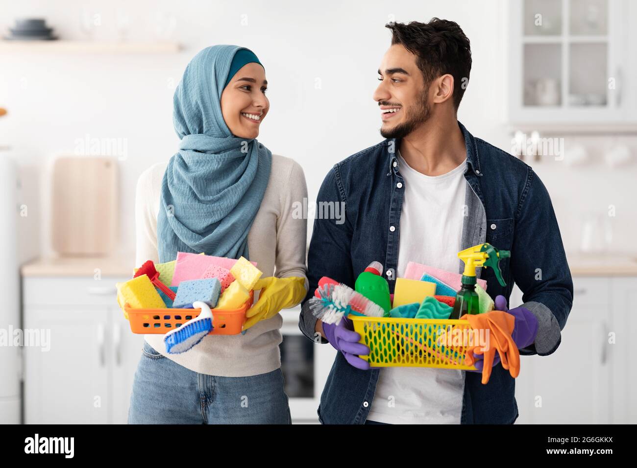 Happy muslim family cleaning their new apartment Stock Photo - Alamy