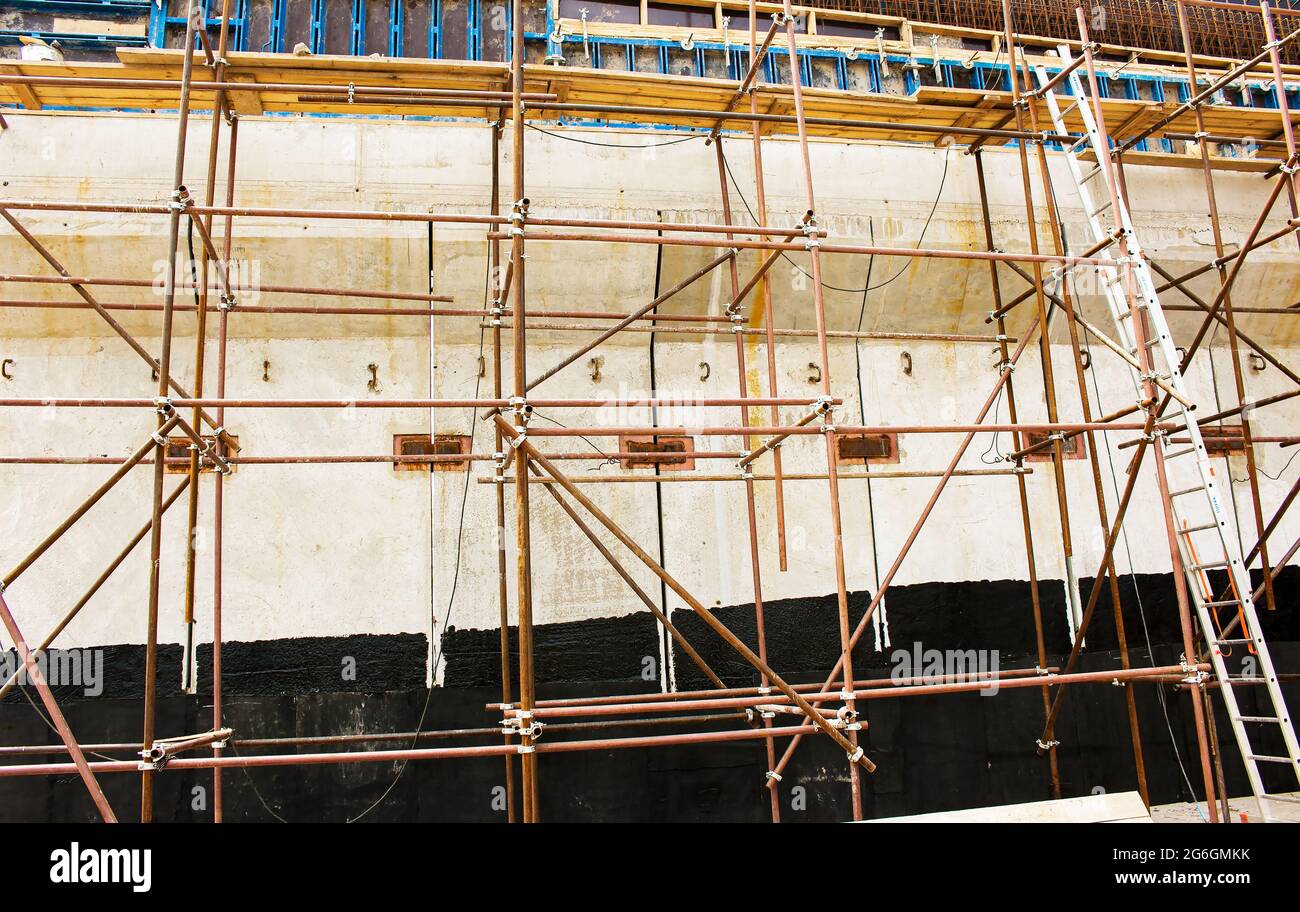 Construction site with scaffolding tower and building. Scaffolding for ...
