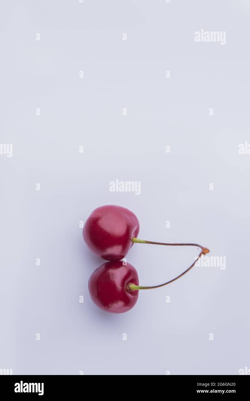 Pair of sweet red cherries isolated on white background Stock Photo - Alamy