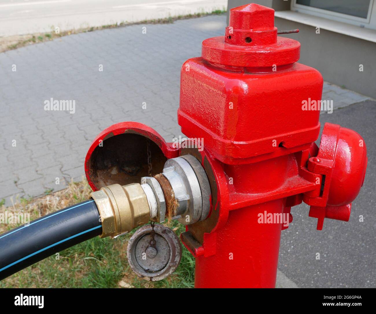 Red fire hydrant on the street Stock Photo - Alamy