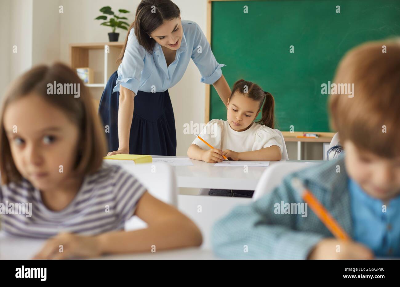 Caring teacher hi-res stock photography and images - Alamy